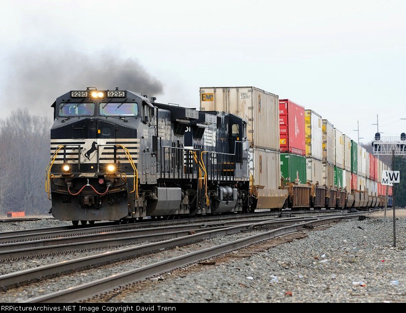 A Westbound NS stack train is lead by NS 9295